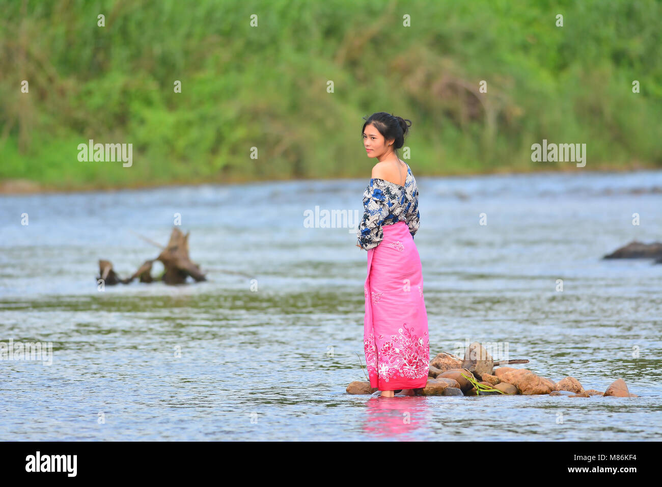 Portrait of young girl in river, Young girl posing on the water Stock ...