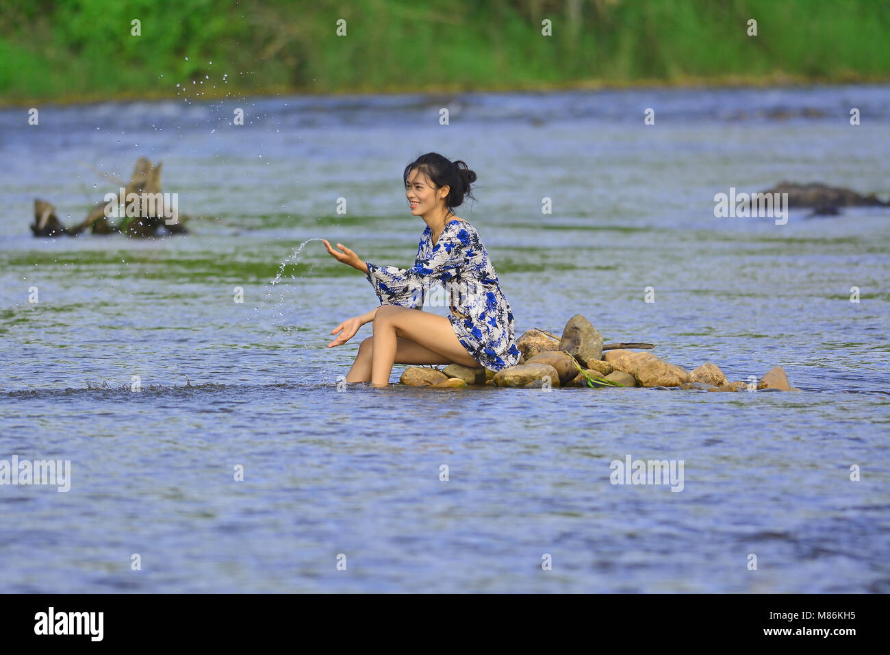 Portrait of young girl in river, Young girl posing on the water Stock ...