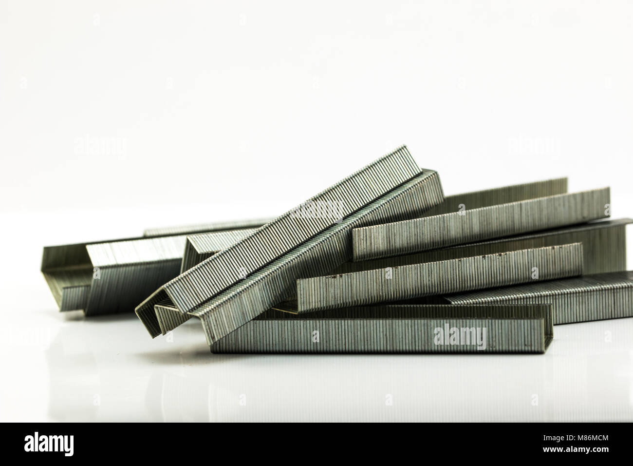 Stack of Staples on white background Stock Photo - Alamy