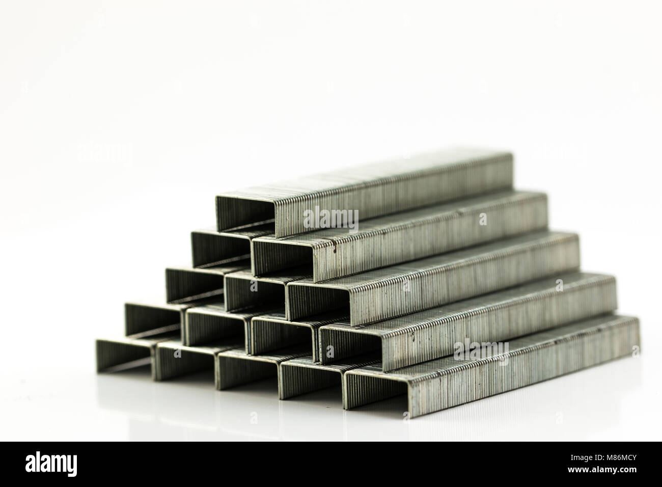 Stack of Staples on white background Stock Photo - Alamy