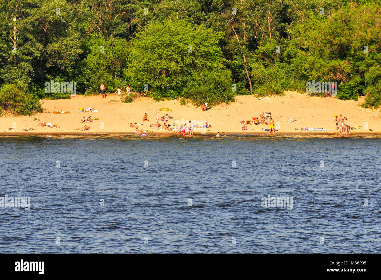 Kiev, Ukraine - June 28, 2009: Sun bathers on the beach in Hydropark in ...