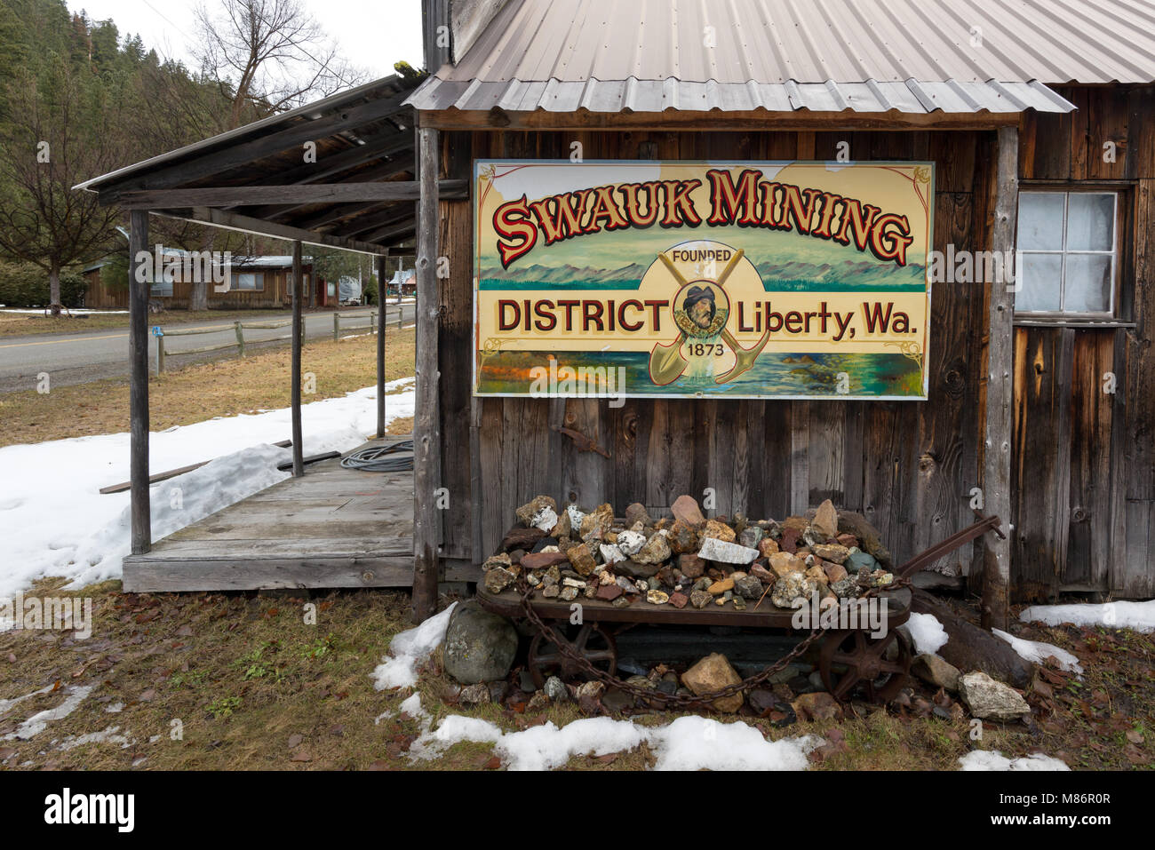 Mine cart and sign on an old building in the historic mining town of ...