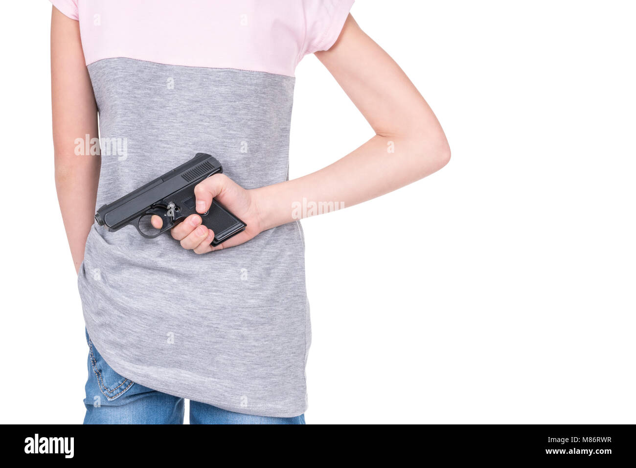 Child hand holds a real gun behind his back isolated on white ...