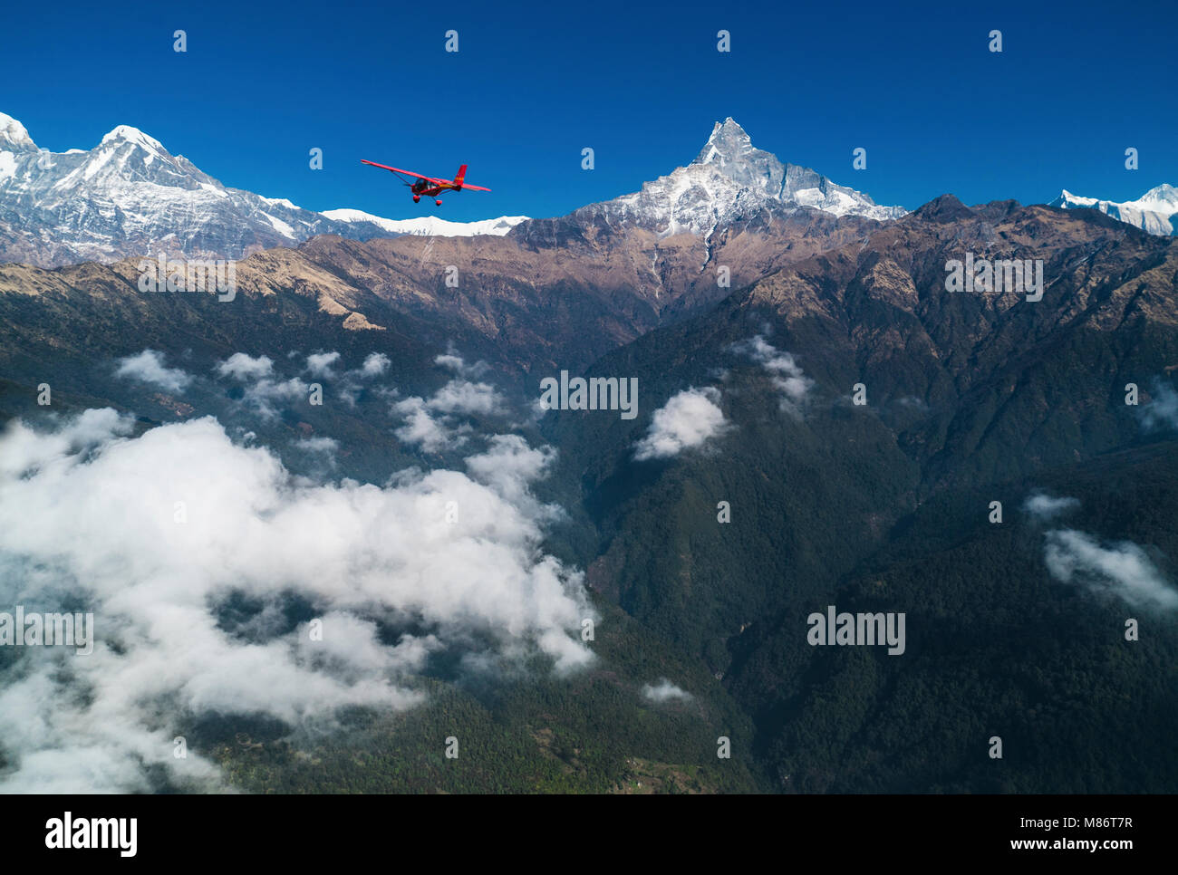 Ultralight plane flies over Pokhara and Annapurna region in Nepal Stock ...