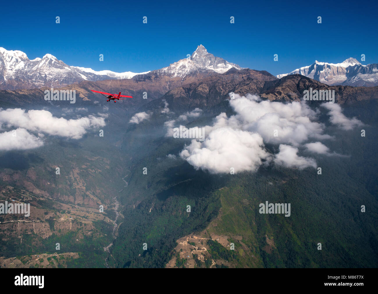 Ultralight plane flies over Pokhara and Annapurna region in Nepal Stock ...
