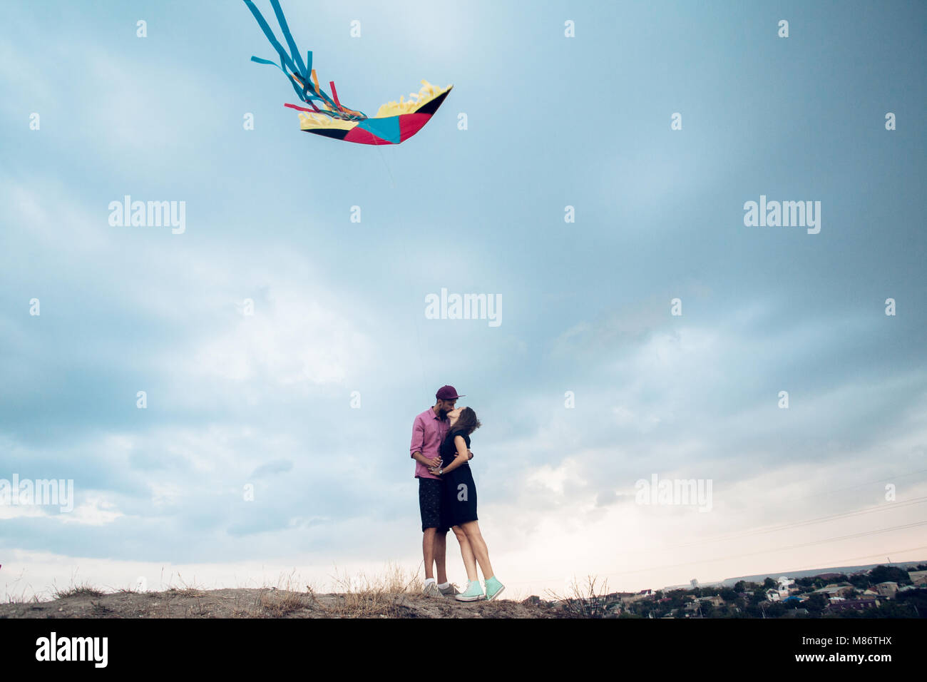 Couple flying a kite Stock Photo - Alamy