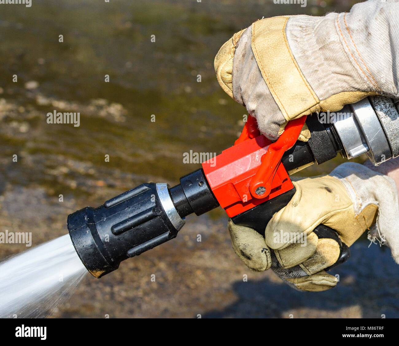 Fire hose in the hands Stock Photo - Alamy