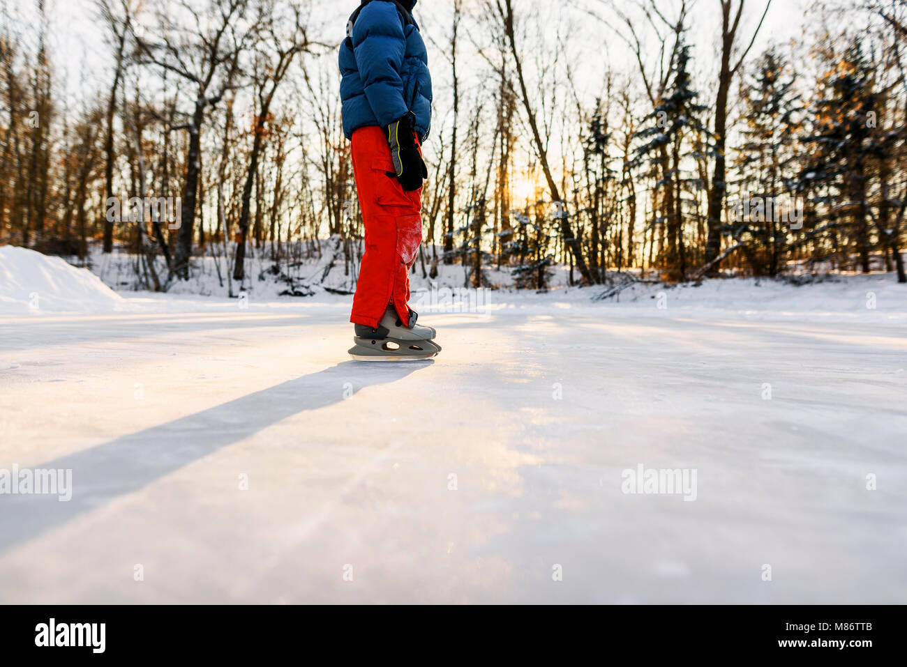 Boy ice-skating on a frozen lake Stock Photo - Alamy