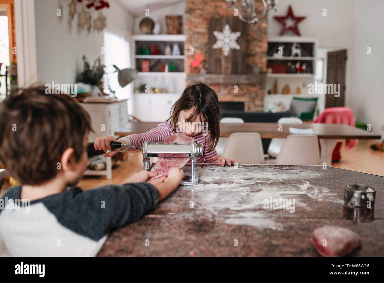 Boy and girl standing in kitchen making pasta Stock Photo - Alamy