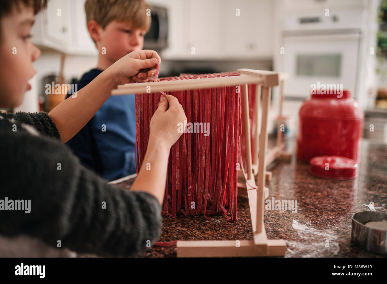 Two boys making fresh pasta Stock Photo - Alamy