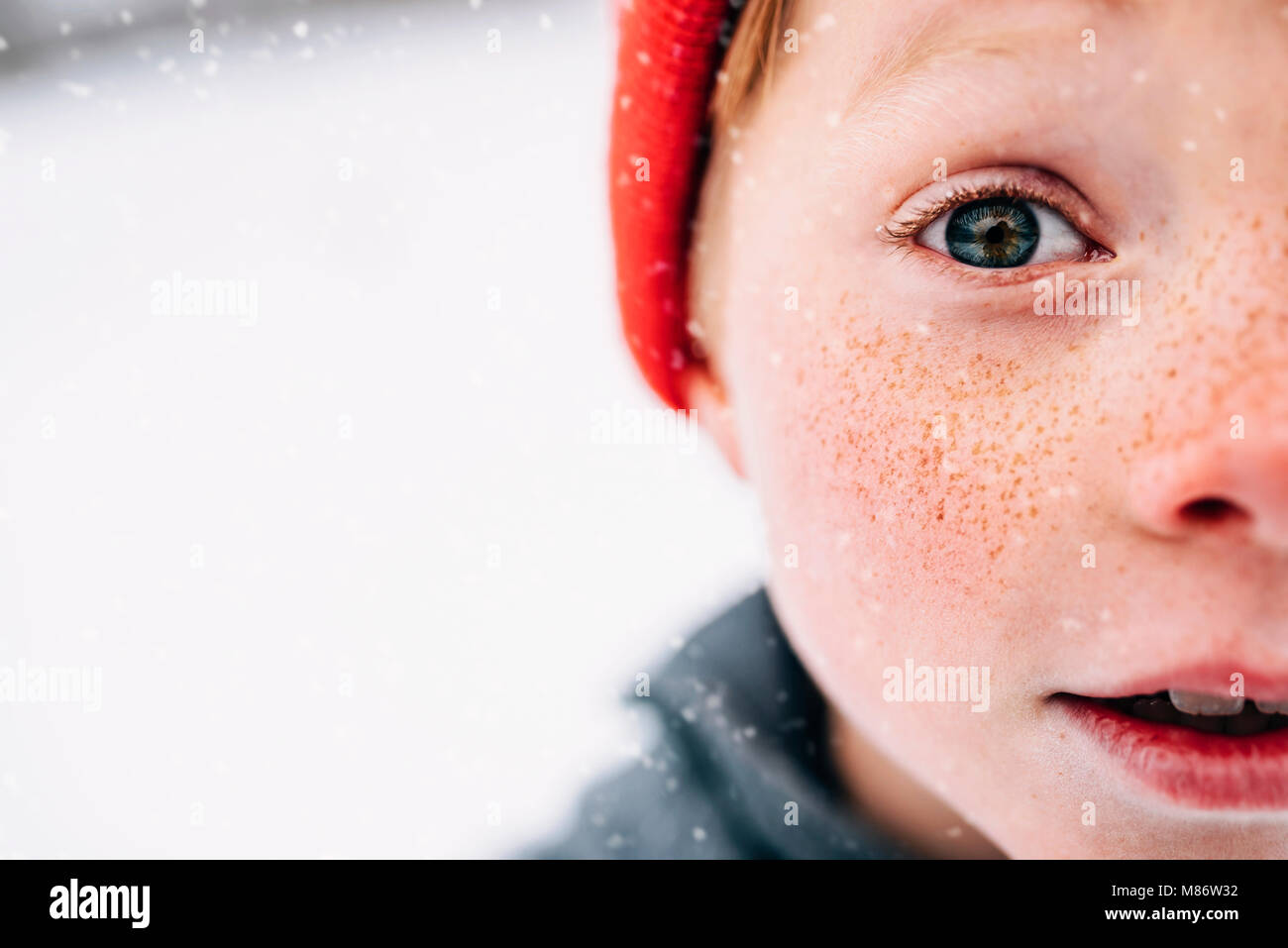 Close-up of a boy with freckles standing in snow Stock Photo - Alamy