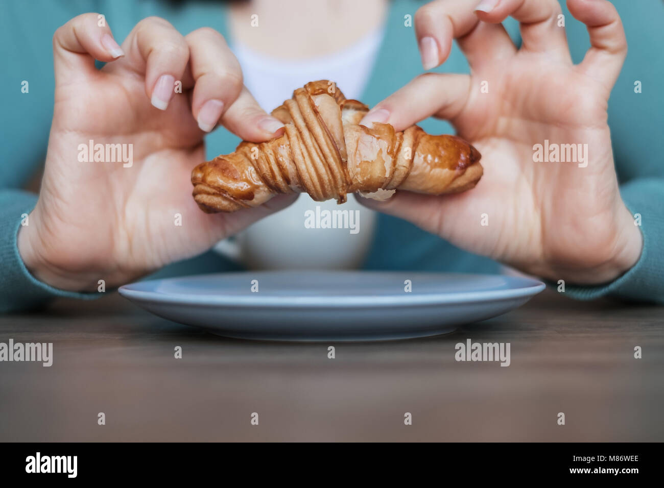 Woman hands holding a croissant Stock Photo - Alamy
