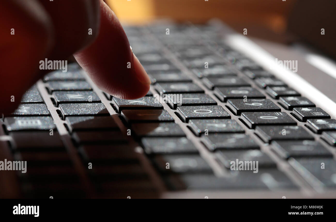 Woman using a computer keyboard Stock Photo - Alamy