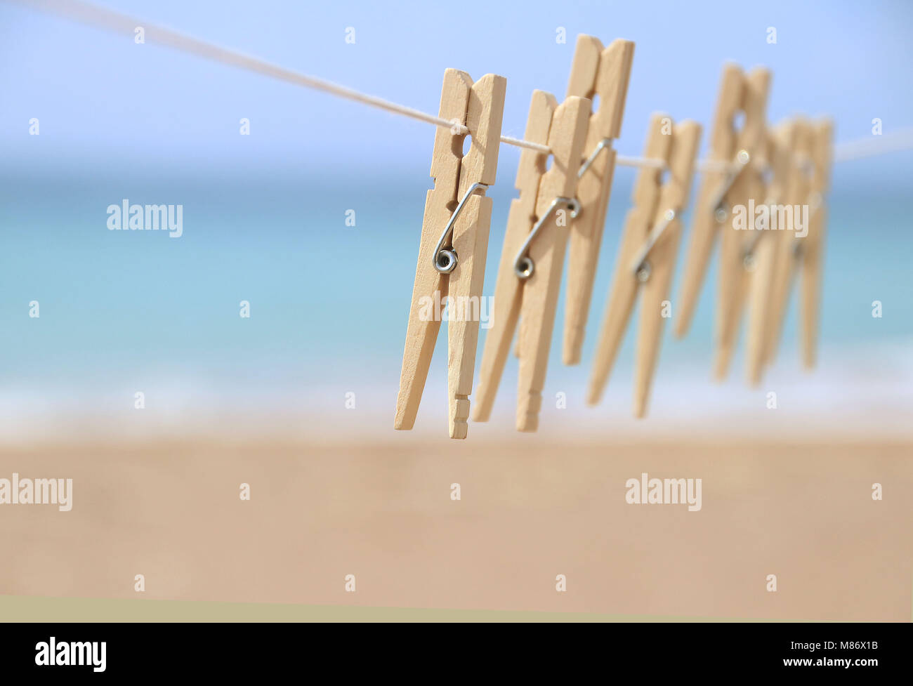 Clothes pegs on a washing line by the beach Stock Photo - Alamy