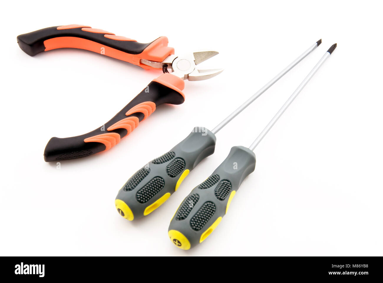 Screwdrivers and cutter isolated on white background Stock Photo - Alamy