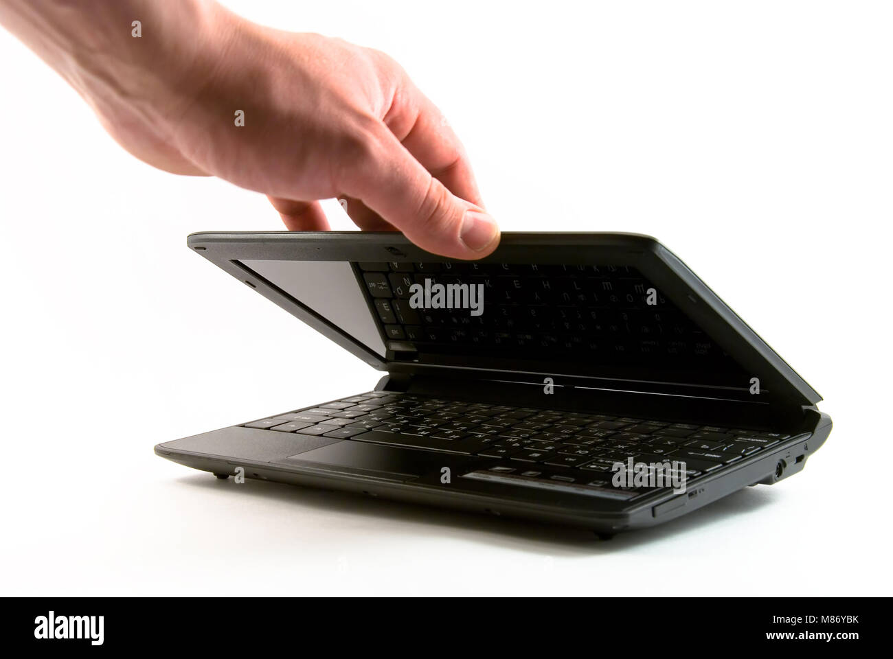 Laptop half closed on white background isolated Stock Photo - Alamy