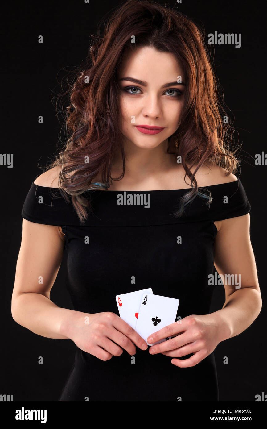Young woman playing in the gambling on black background Stock Photo - Alamy