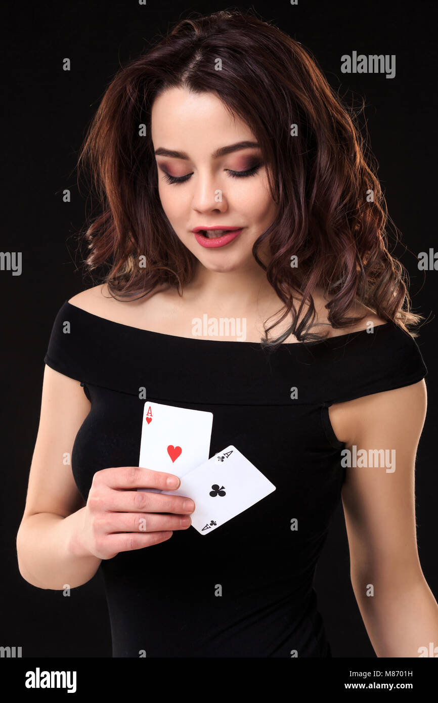 Young woman playing in the gambling on black background Stock Photo - Alamy