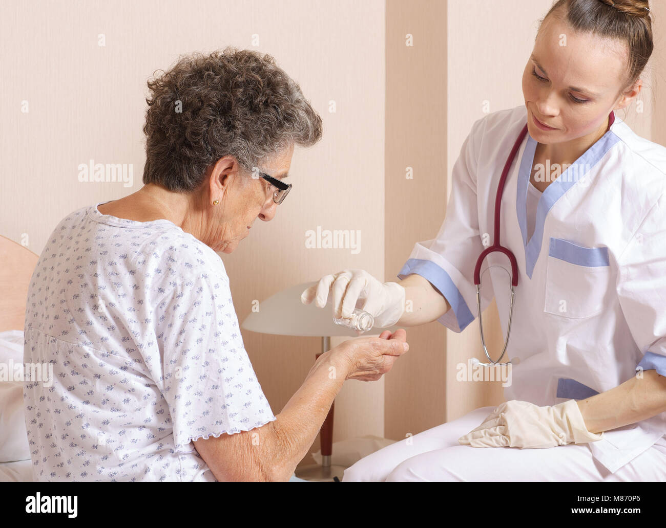 Geriatrician visits a senior woman between 70 and 80 years old in her ...