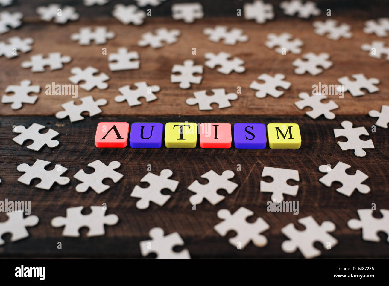 Colourful jigsaw puzzle and alphabet tiles with AUTISM word. Autism ...