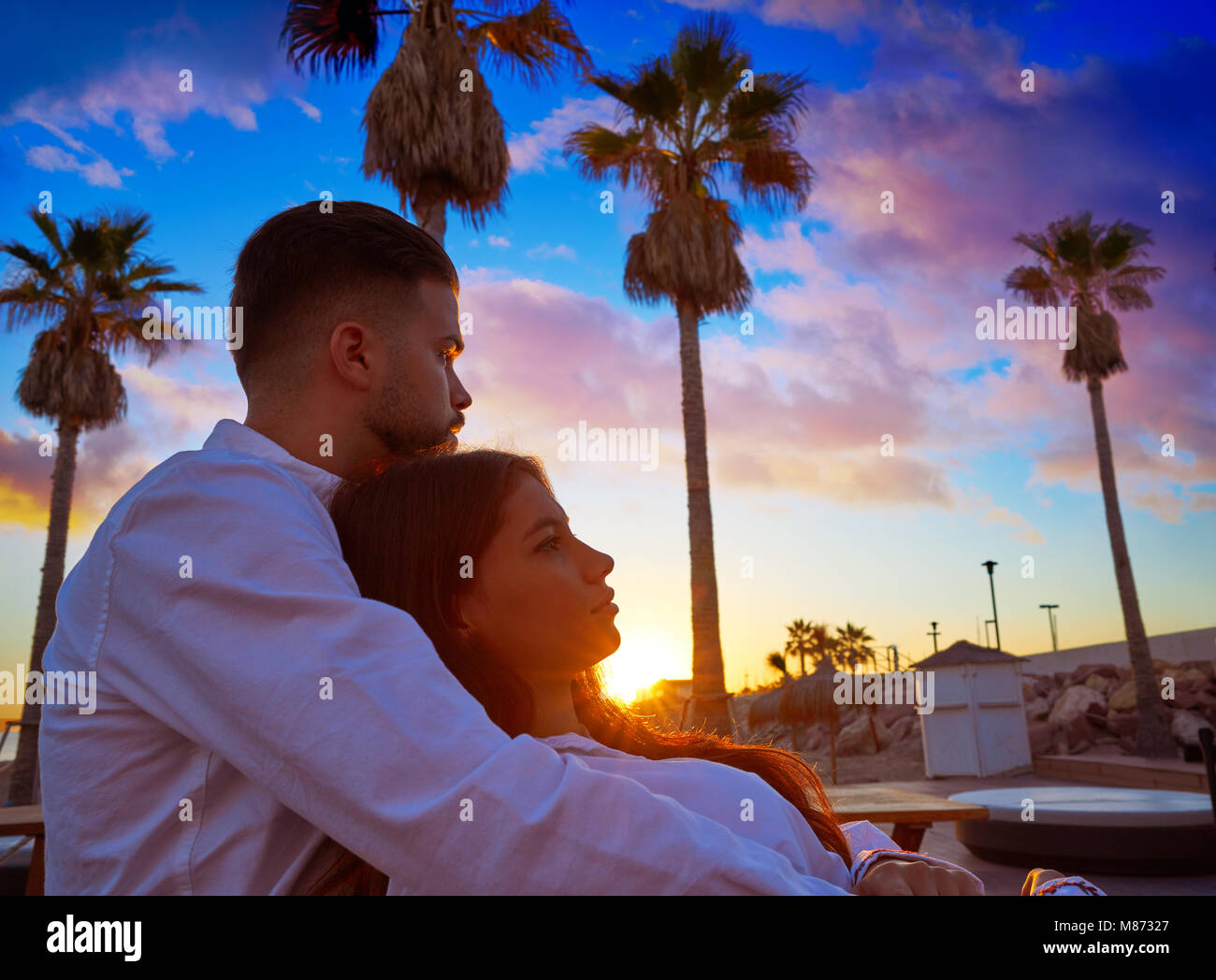 Couple young hug in beach vacation sunrise in Spain Stock Photo - Alamy