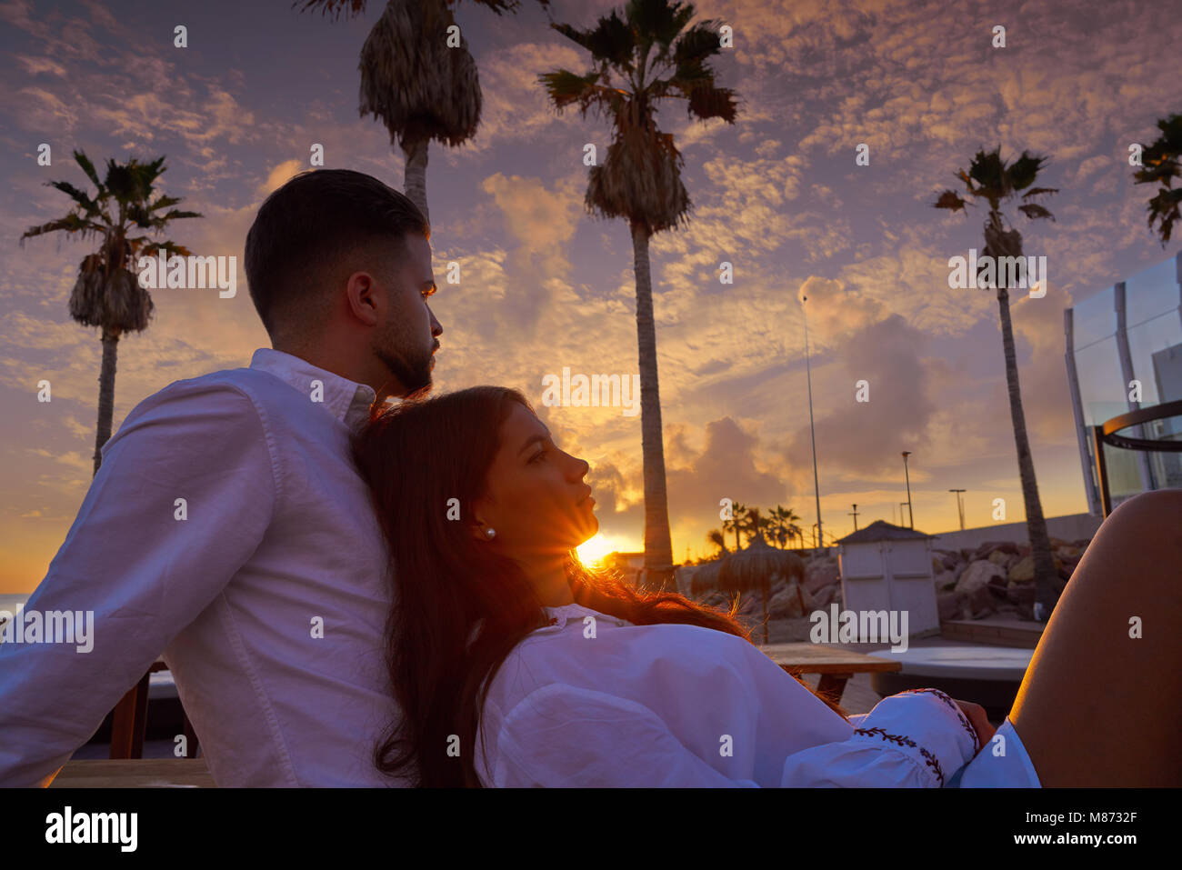 Couple young hug in beach vacation sunrise in Spain Stock Photo - Alamy