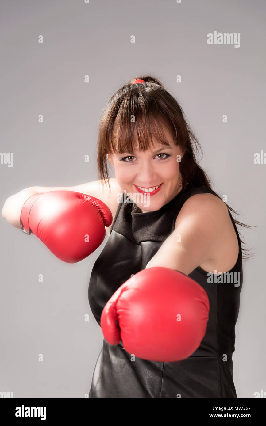 Woman wearing a black leather dress and red boxing gloves Stock Photo ...