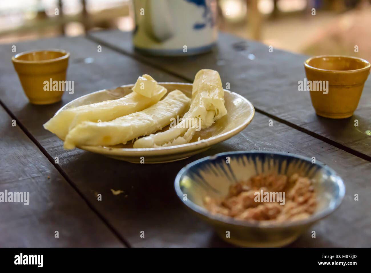 Plate of tapioca root which is dipped into a mix of salt, pepper and ...