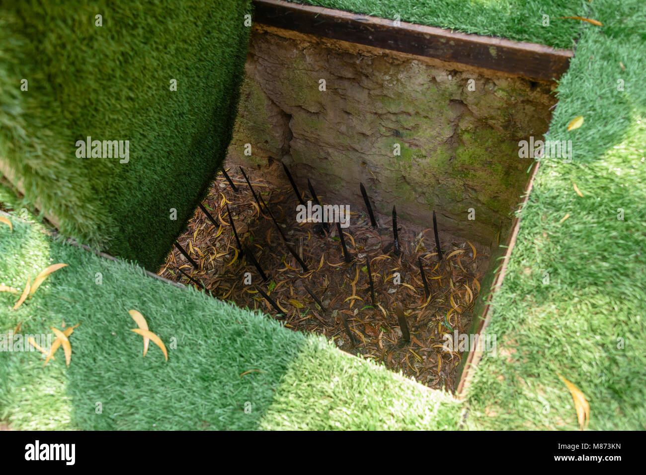 Mantrap formed from a hole in the ground with spikes (punji sticks) at ...