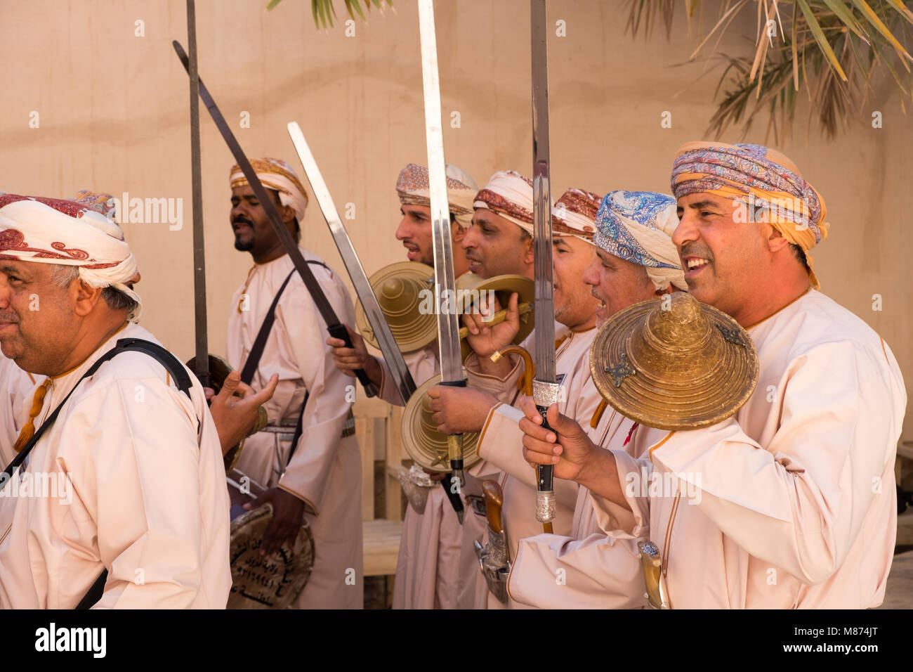 Nizwa, Oman - Omani men dancing a traditional sword dance at Nizwa Fort ...