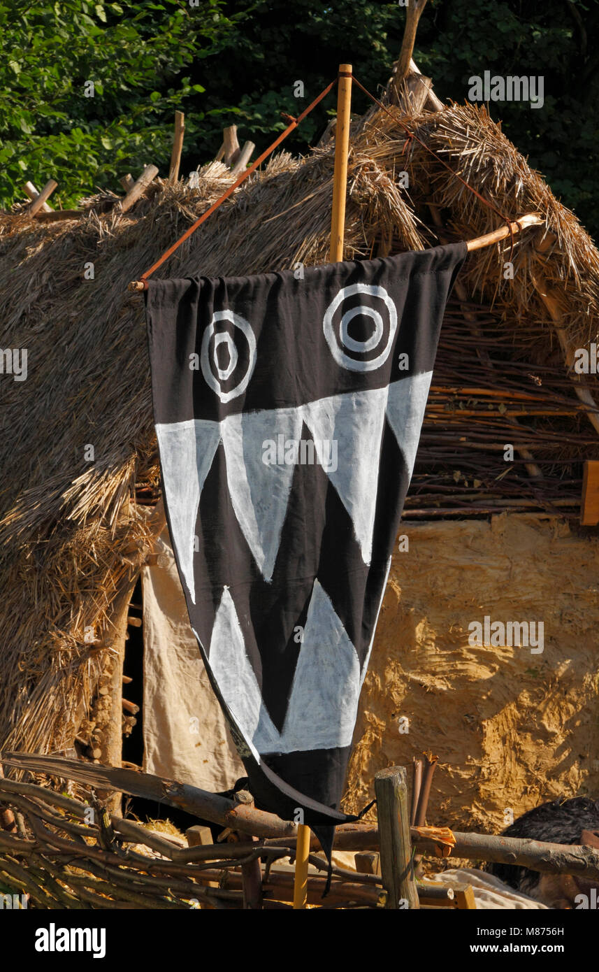 Flag on front of ancient home reconstruction at Archeological Festival ...