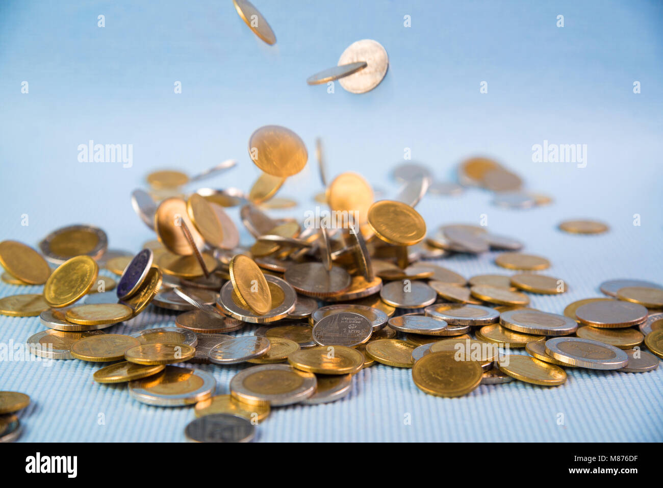 Falling coins money on blue background, business wealth concept idea ...