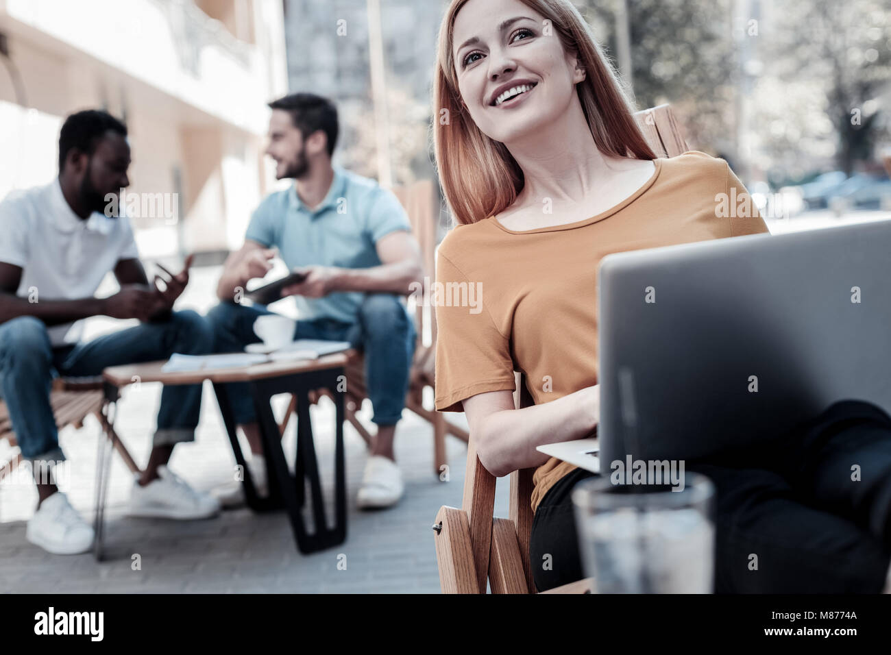 Curious young woman looking at something with interest Stock Photo - Alamy