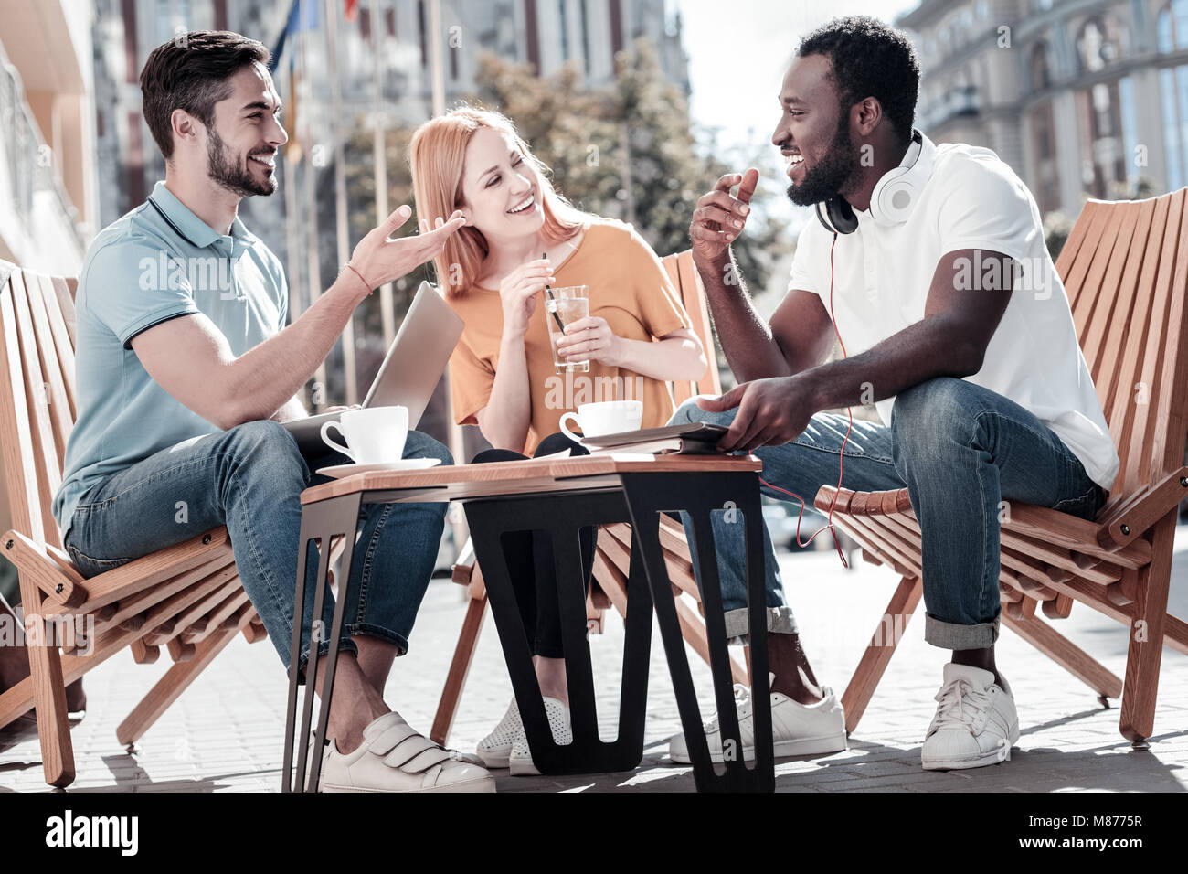 Millennial friends smiling while meeting in cafe Stock Photo - Alamy