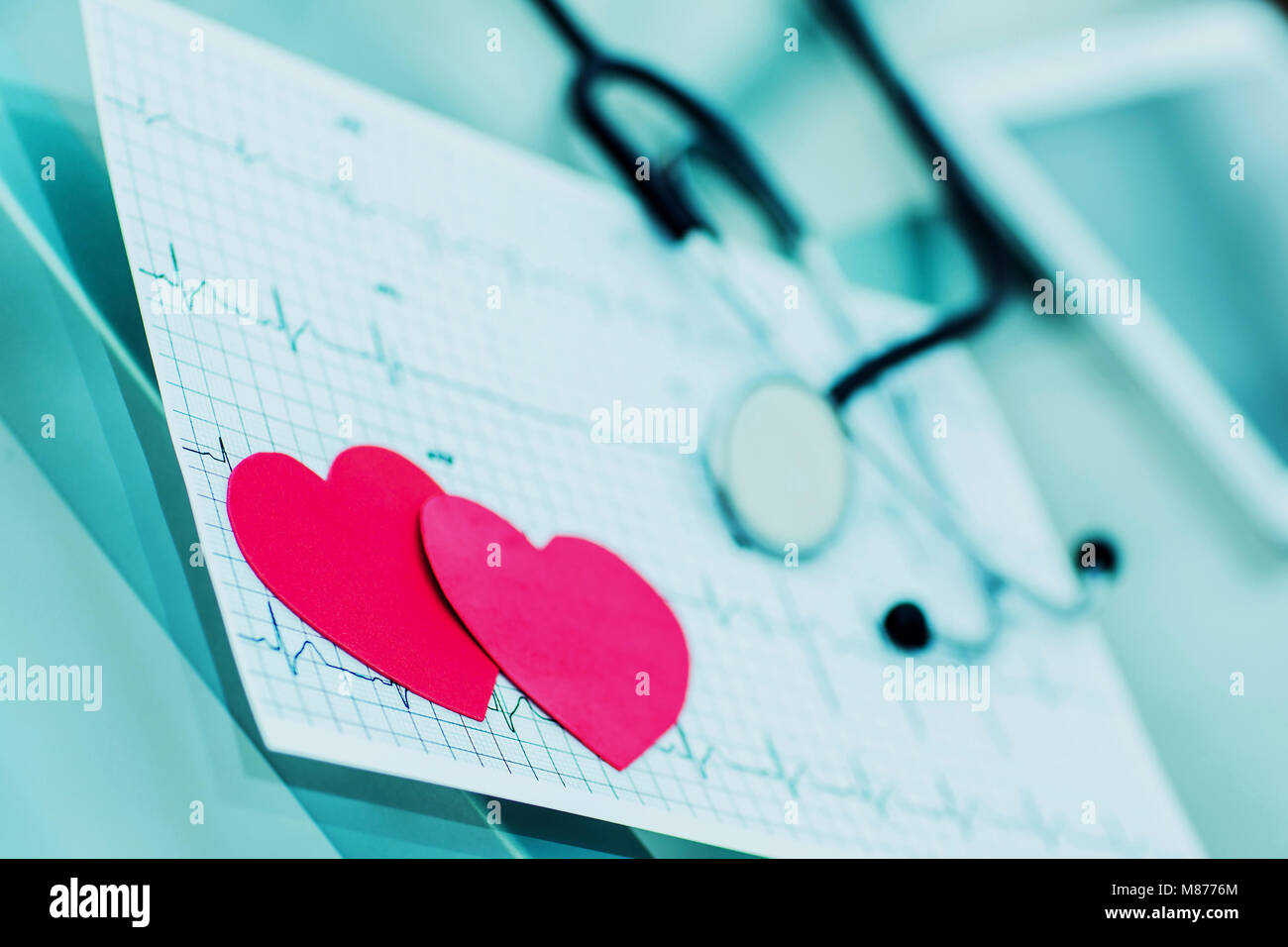 health concept: two red paper heart on the electrocardiogram, the ...