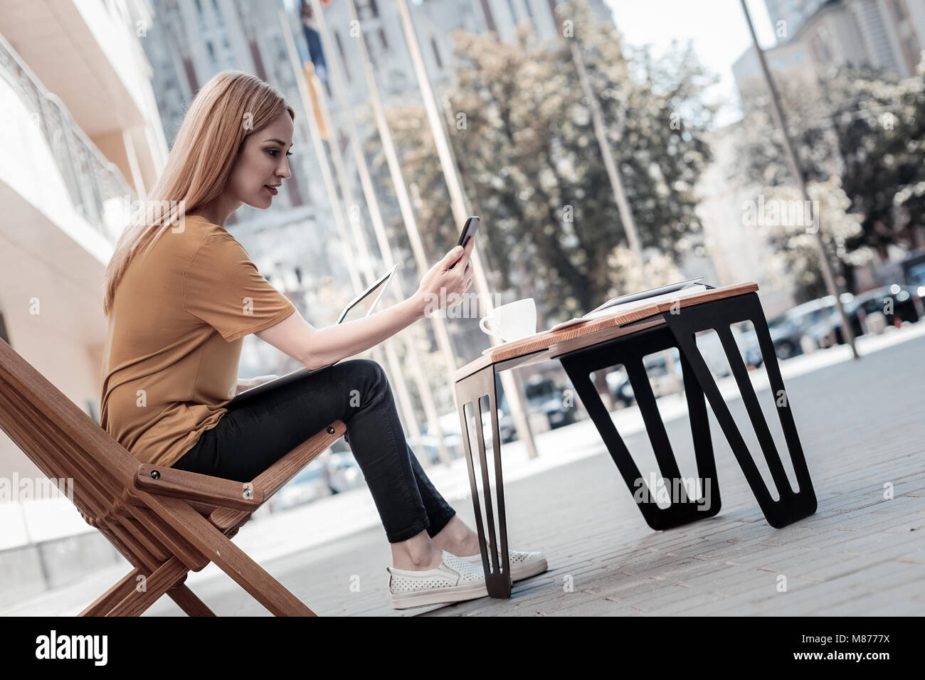 Smart millennial lady working in cafe Stock Photo - Alamy