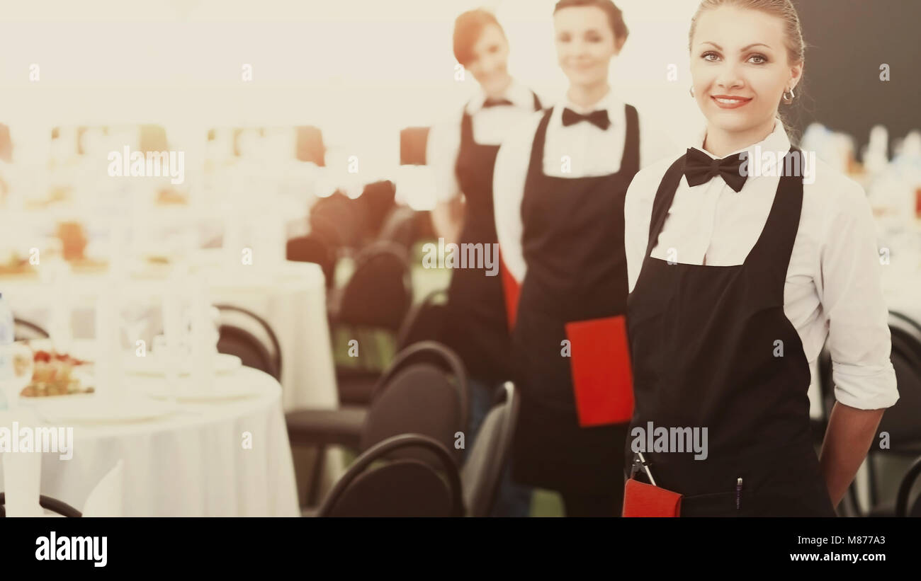 A large group of waiters and waitresses next to served tables Stock ...