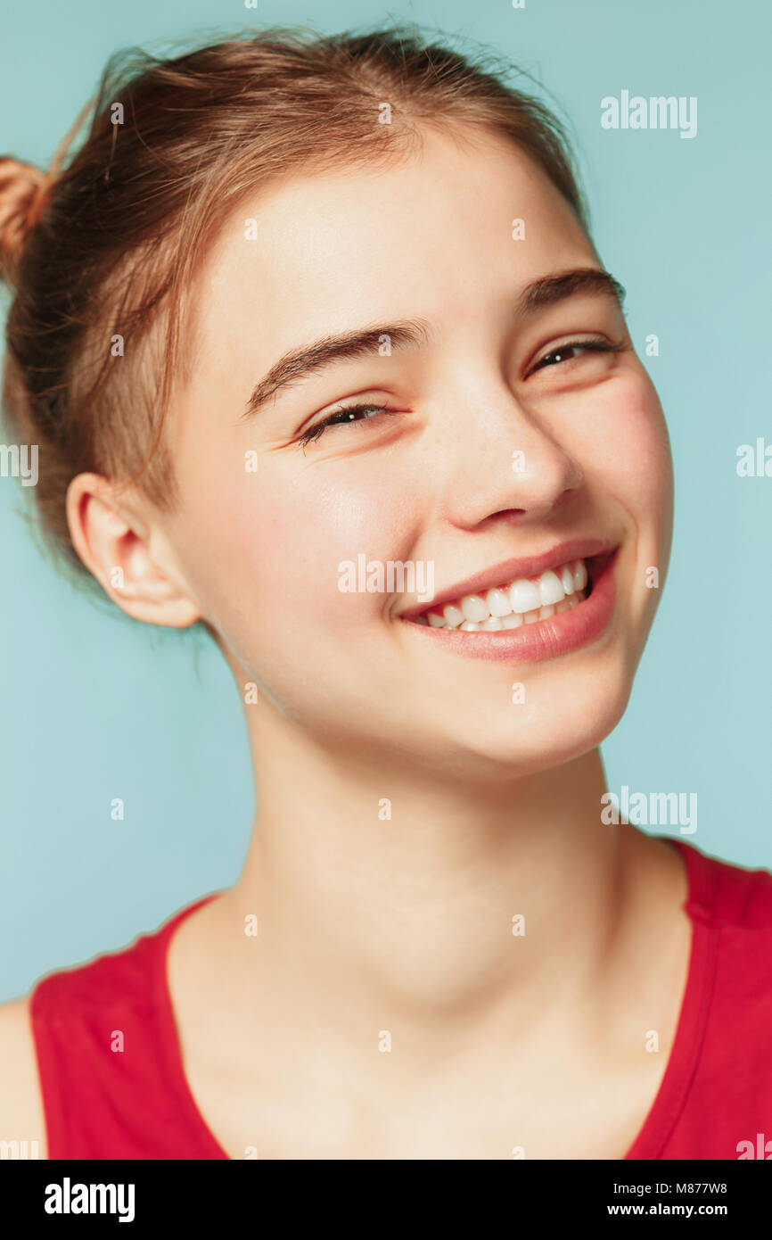Woman smiling with perfect smile on the blue studio background and ...
