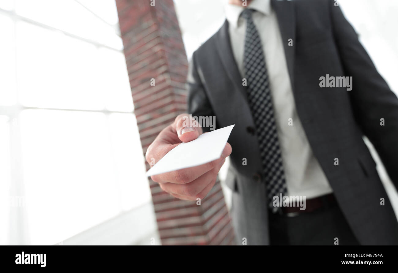 Businessman giving a card. Close-up photo in loft office Stock Photo ...
