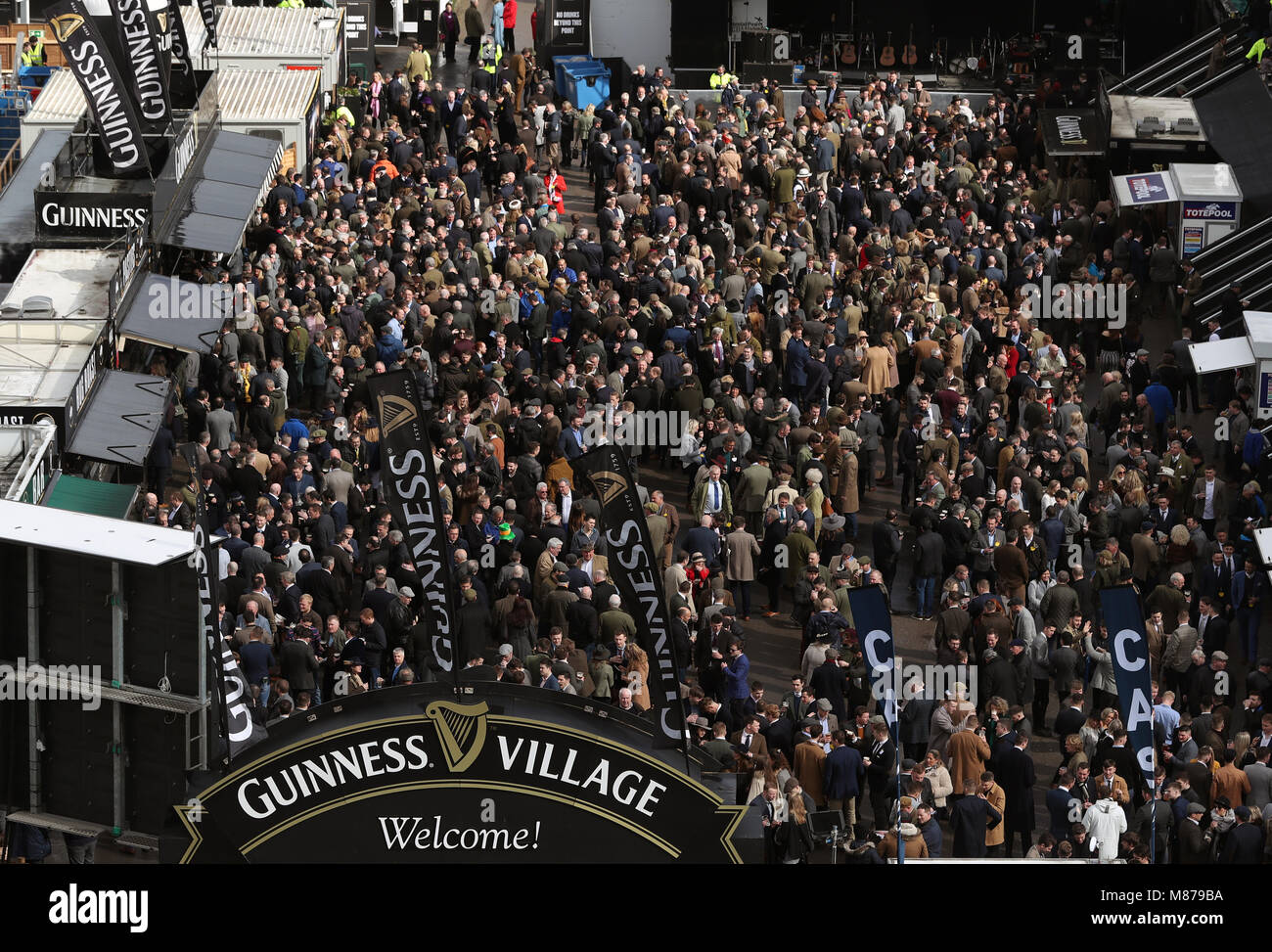 Racegoers gather in Guinness Village during St Patrick's Thursday of ...