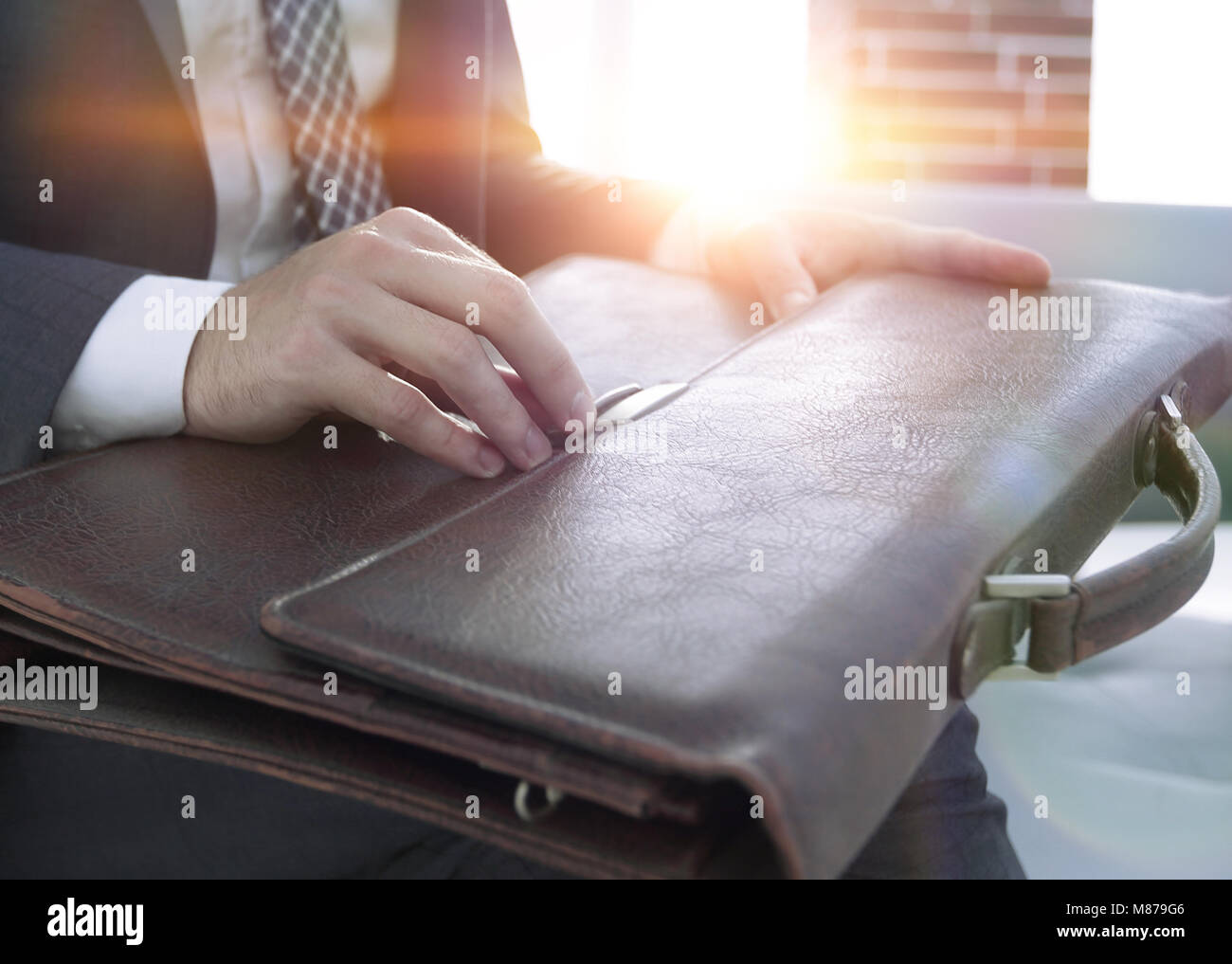 businessman's hand with suitecase in a modern office Stock Photo - Alamy