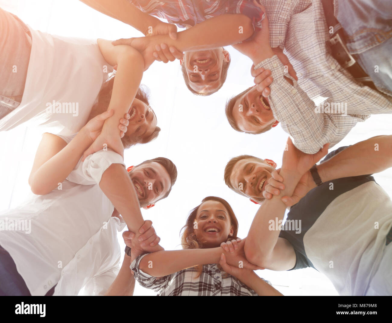 Happy group of businesspeople stacking their hands in cooperation Stock ...