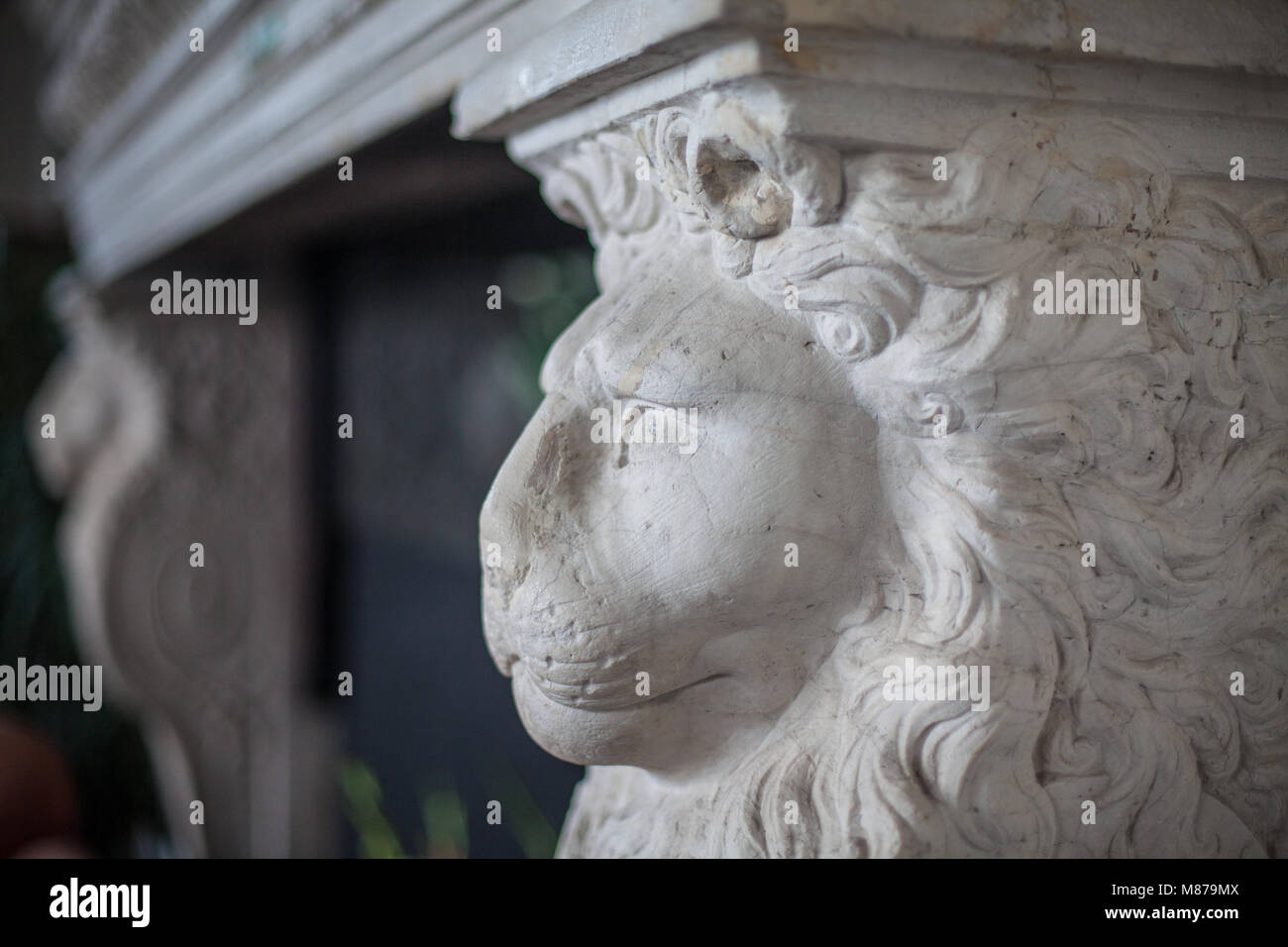 a lions head sculpture on a fire place mantle piece in an old house in ...