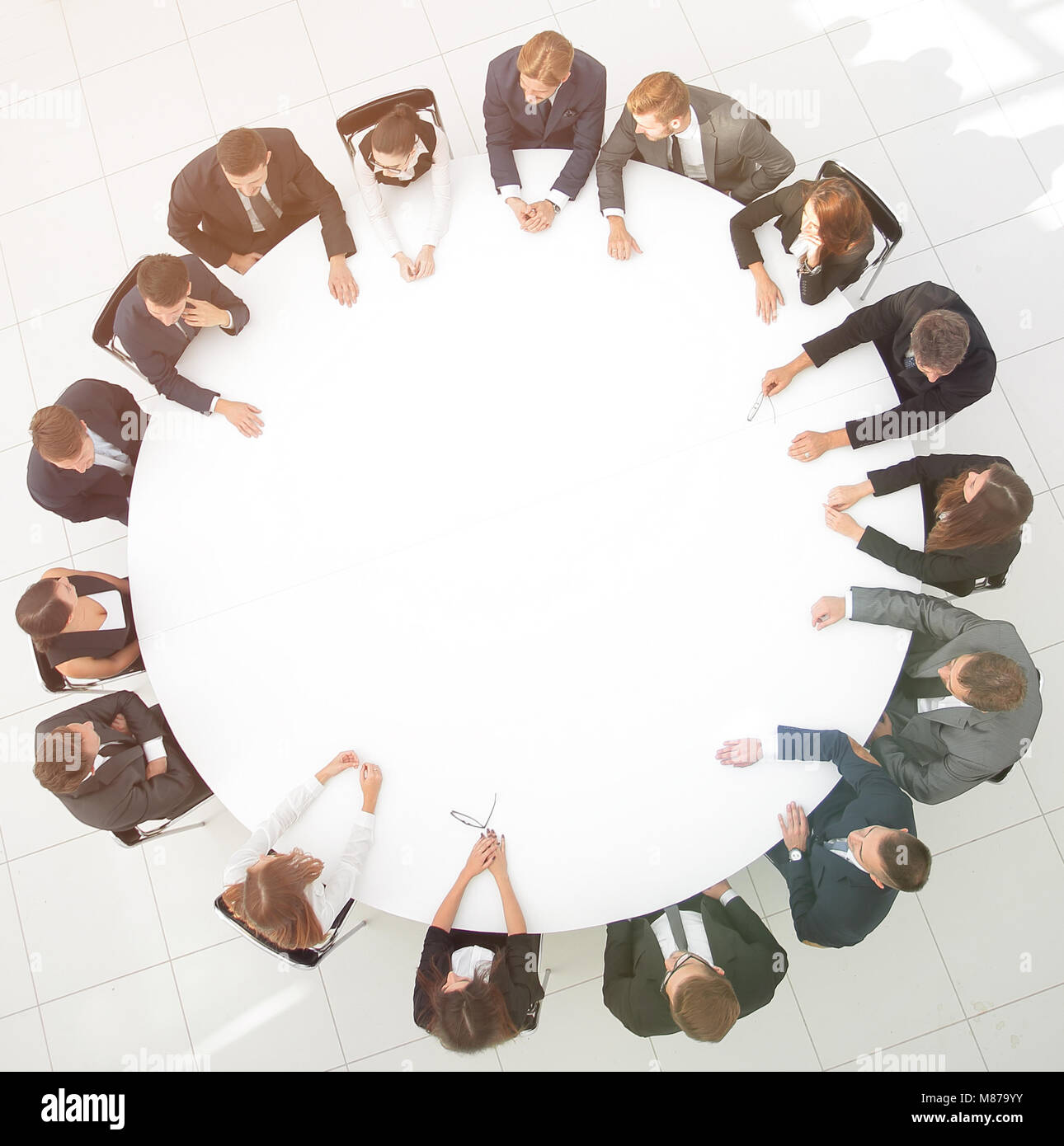 large group of business people sitting at the round table. the b Stock ...