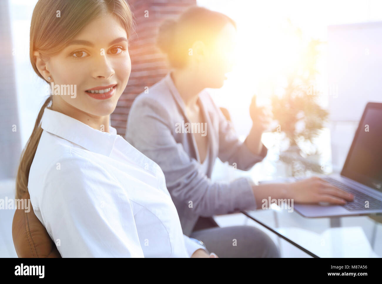 office workers sitting behind a Desk Stock Photo - Alamy