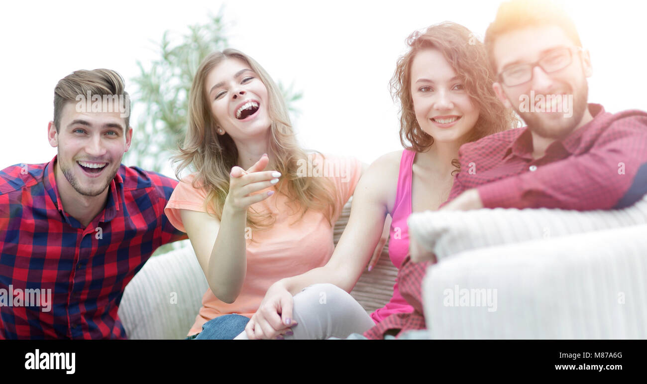 group of happy young people sitting on the couch Stock Photo - Alamy