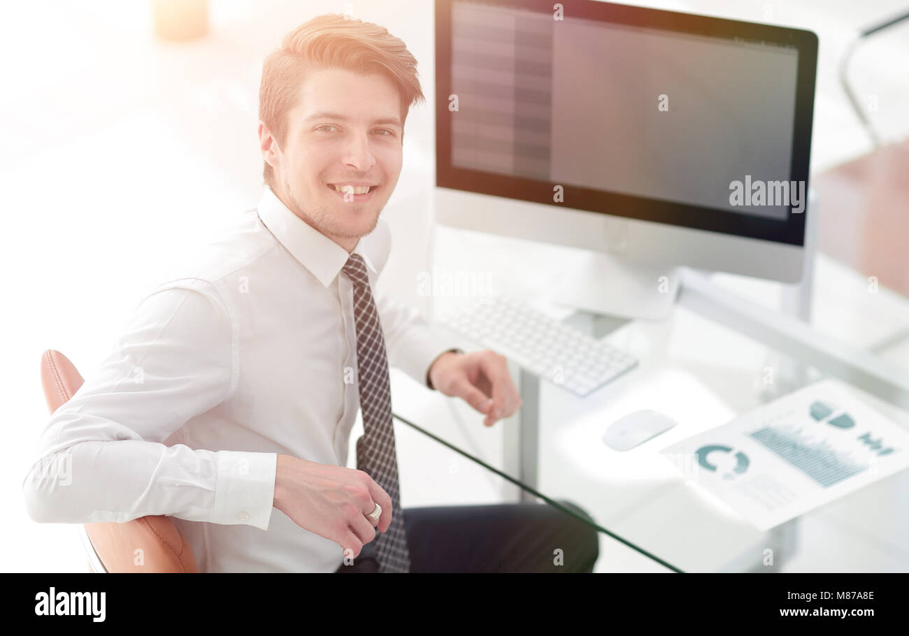 employee sitting in front of a computer screen Stock Photo - Alamy