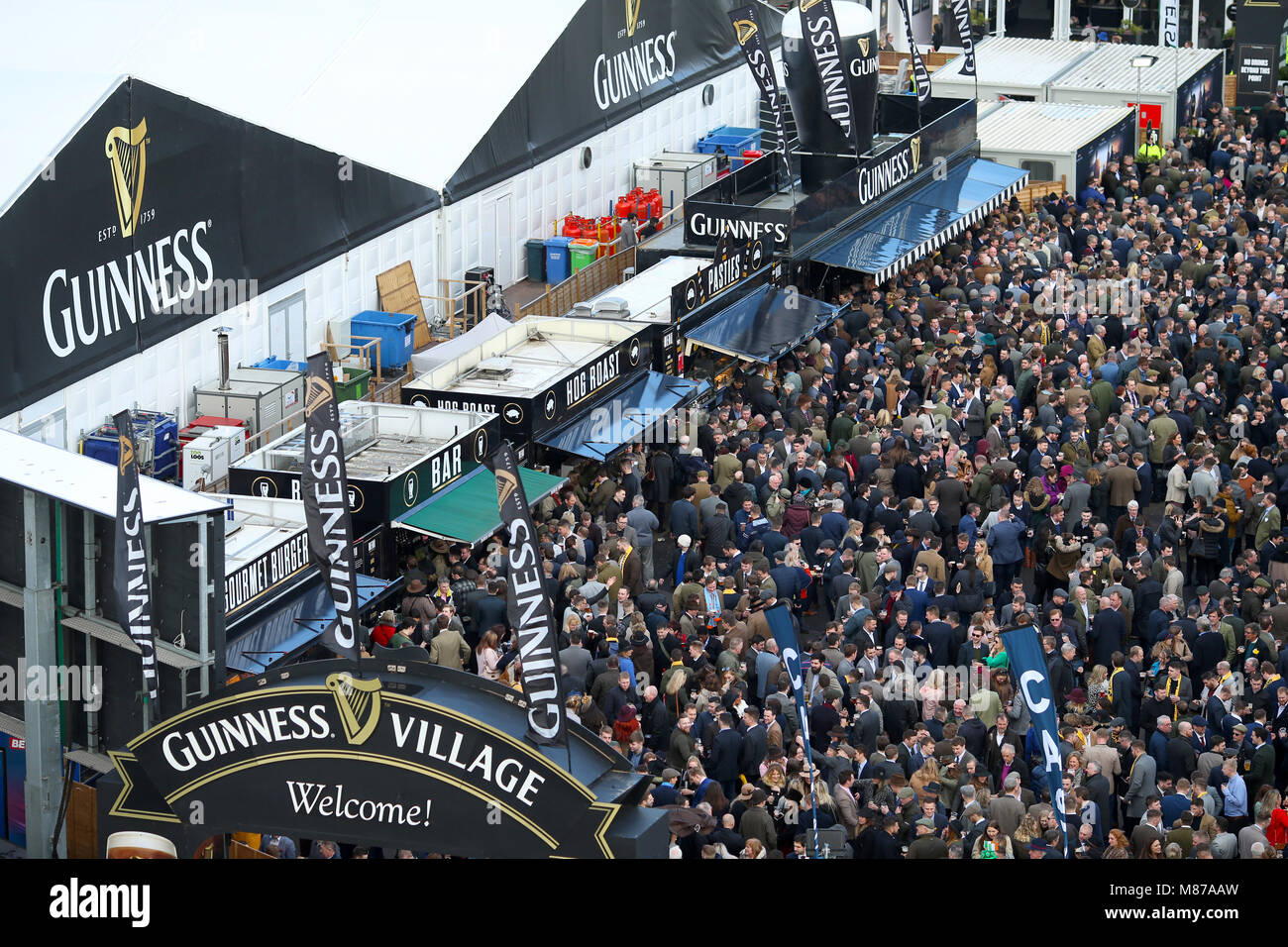 General view racegoers enjoying guinness village hi-res stock ...