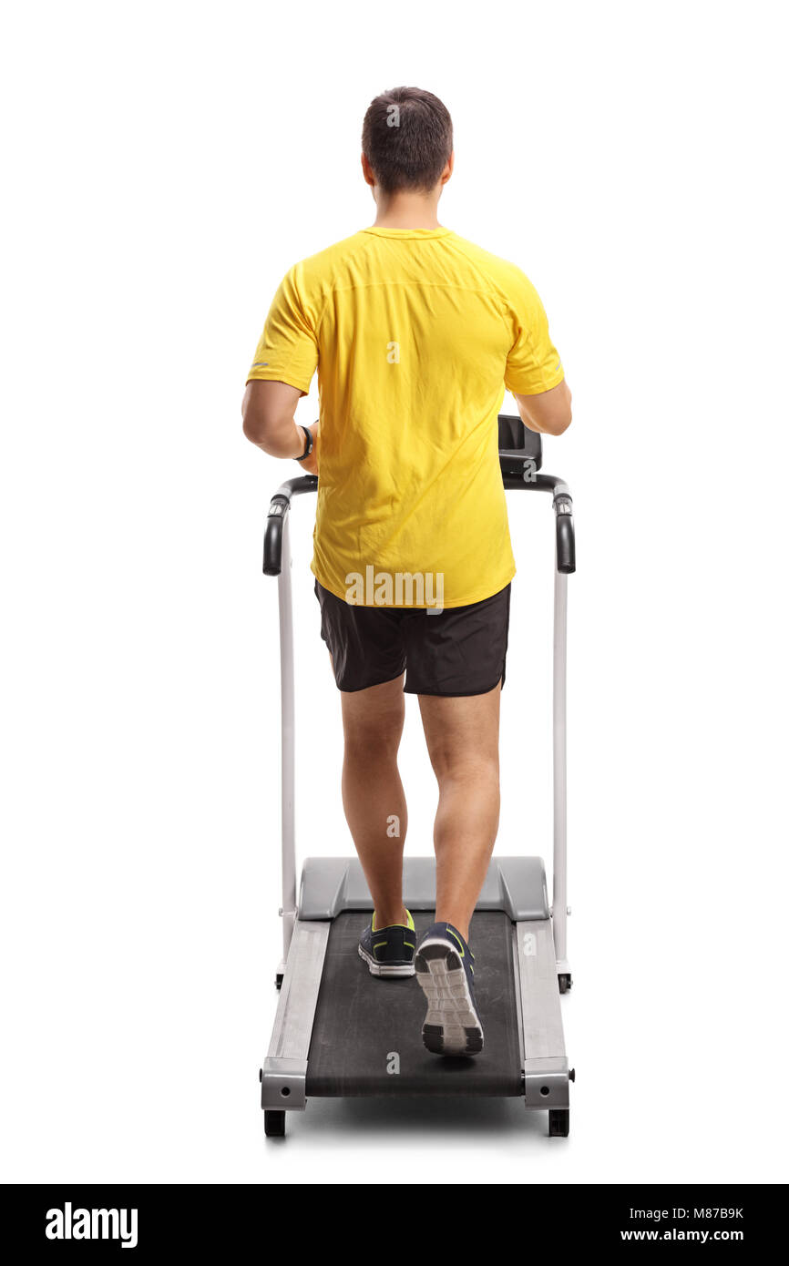 Full length rear view shot of a young man exercising on a treadmill ...