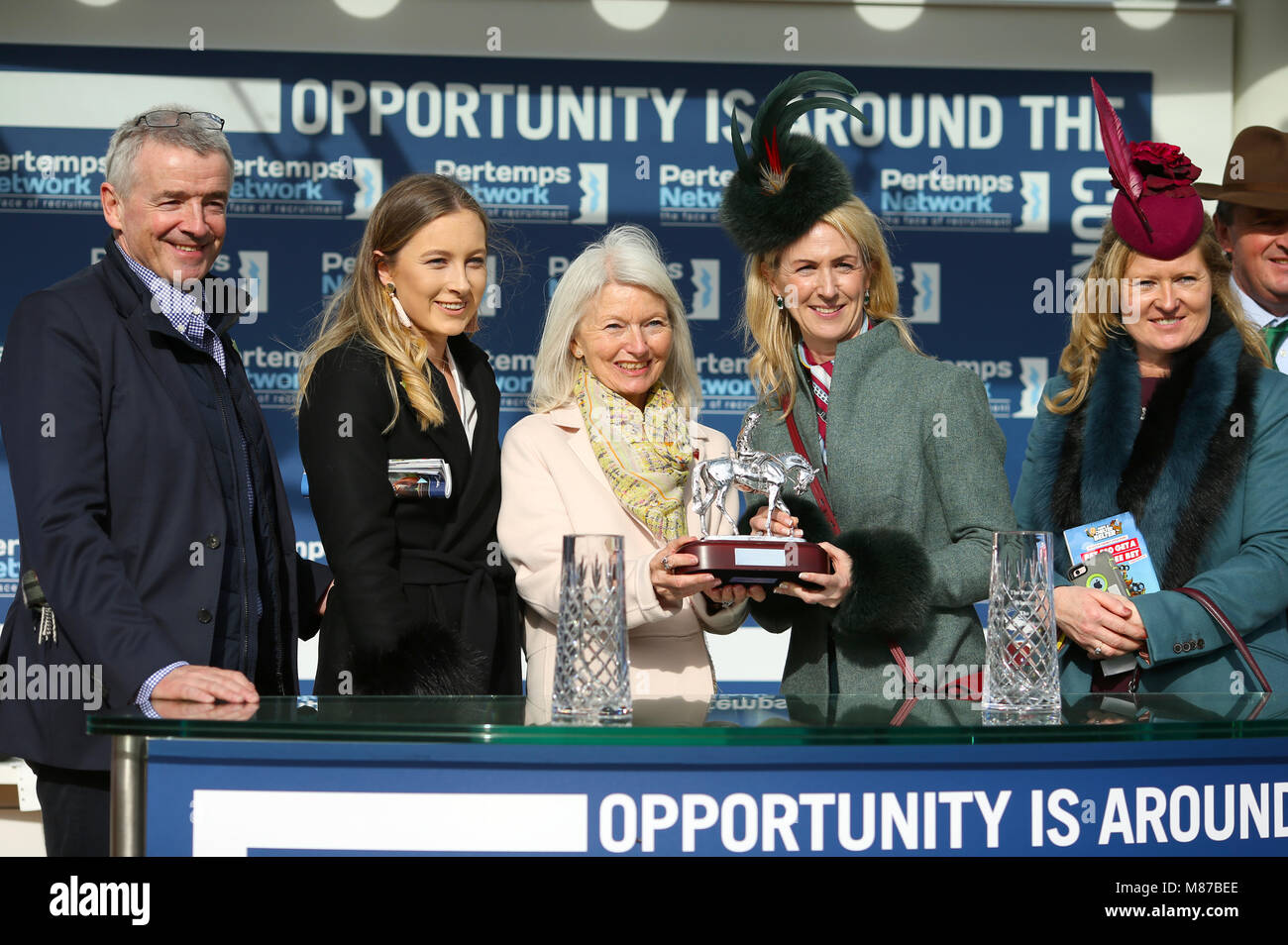 Owner Michael O'Leary (left) and winning connections collect the trophy ...
